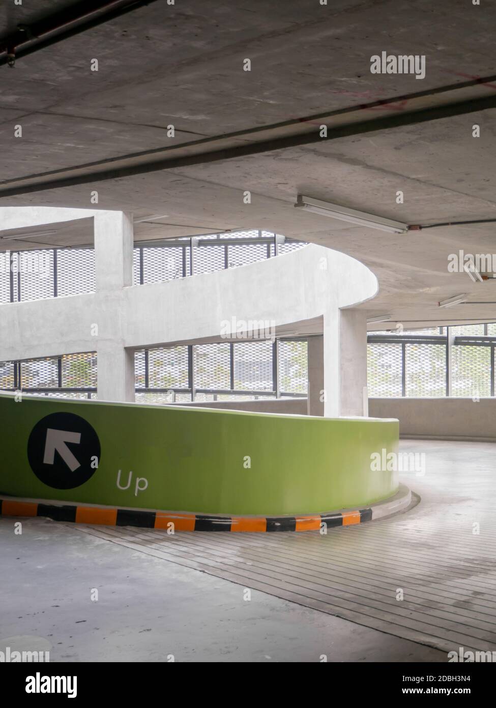 ramp of a parking structure. There is a yellow, black symbol. This ...