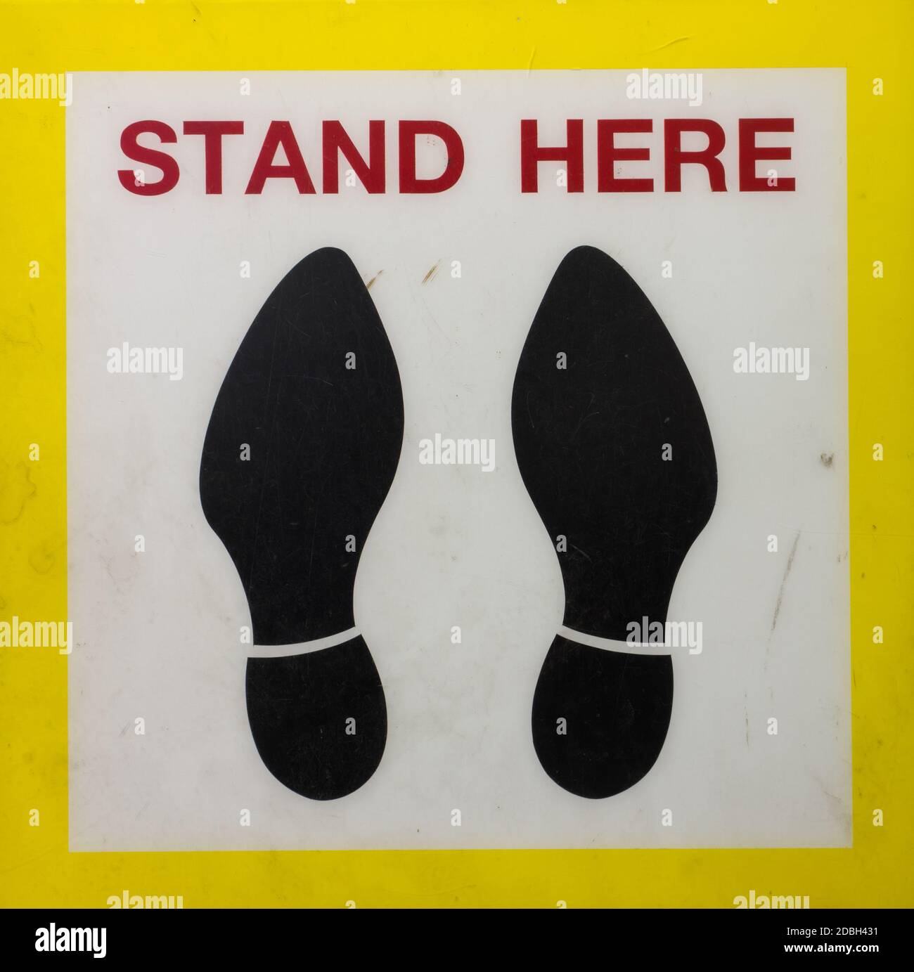 Yellow color Sticker Stand here foot label Stock Photo - Alamy