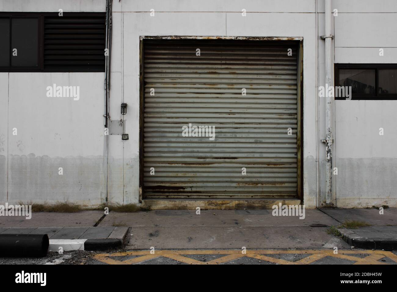 Shutter door still inside the factory security Stock Photo - Alamy