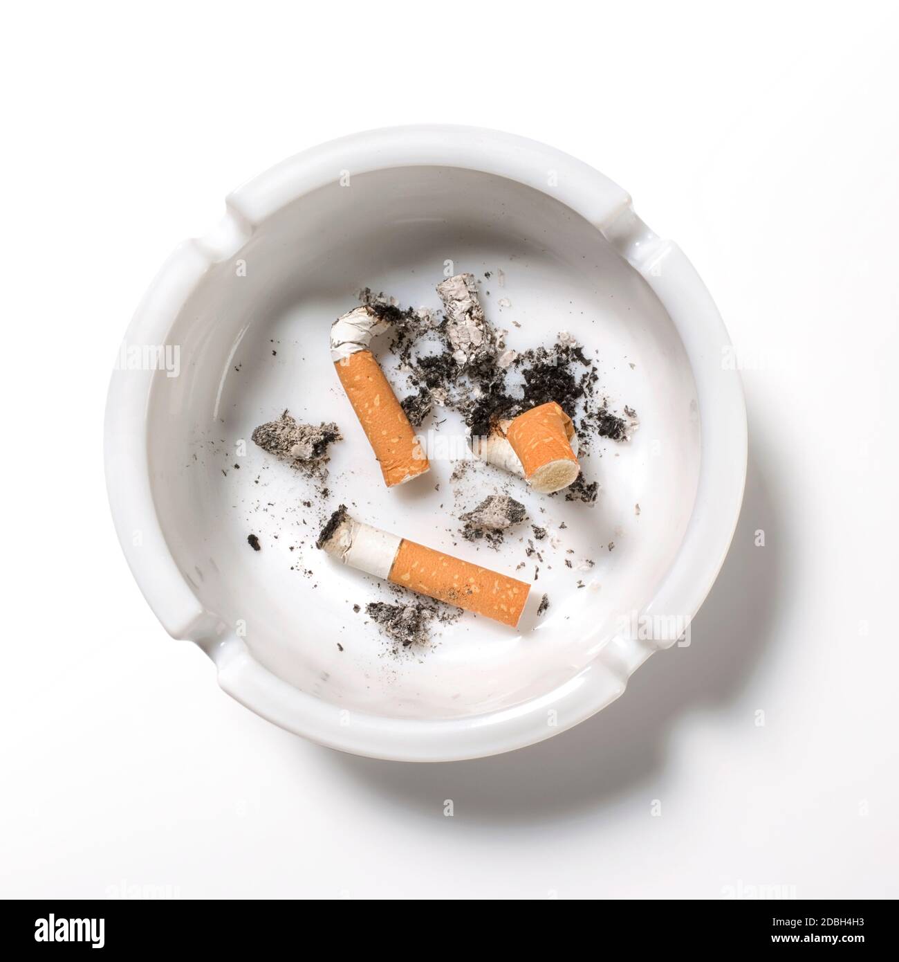Dirty ashtray with cigarette butts and cigarette isolated against white ...