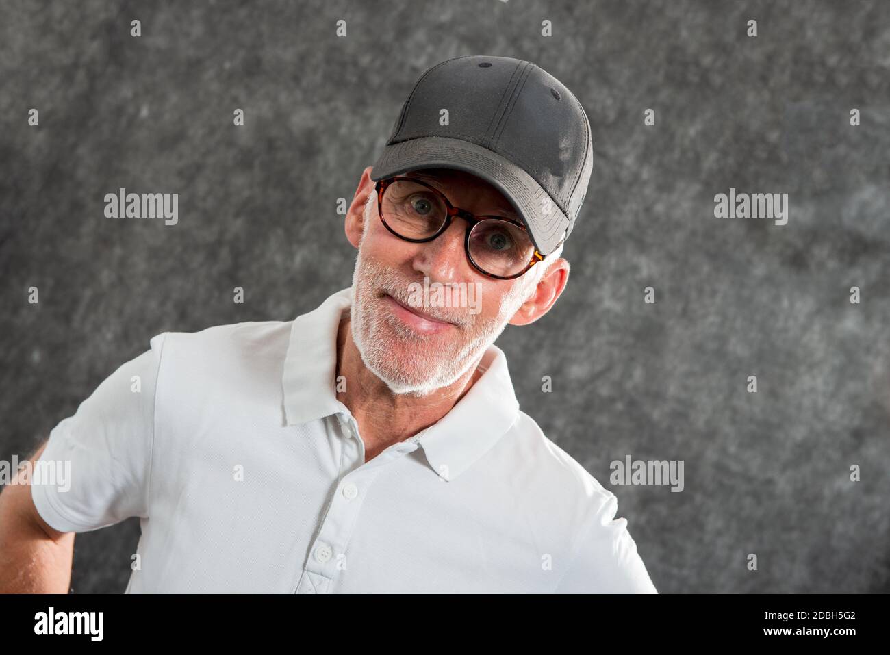 a sixty year old man wearing a baseball cap Stock Photo - Alamy