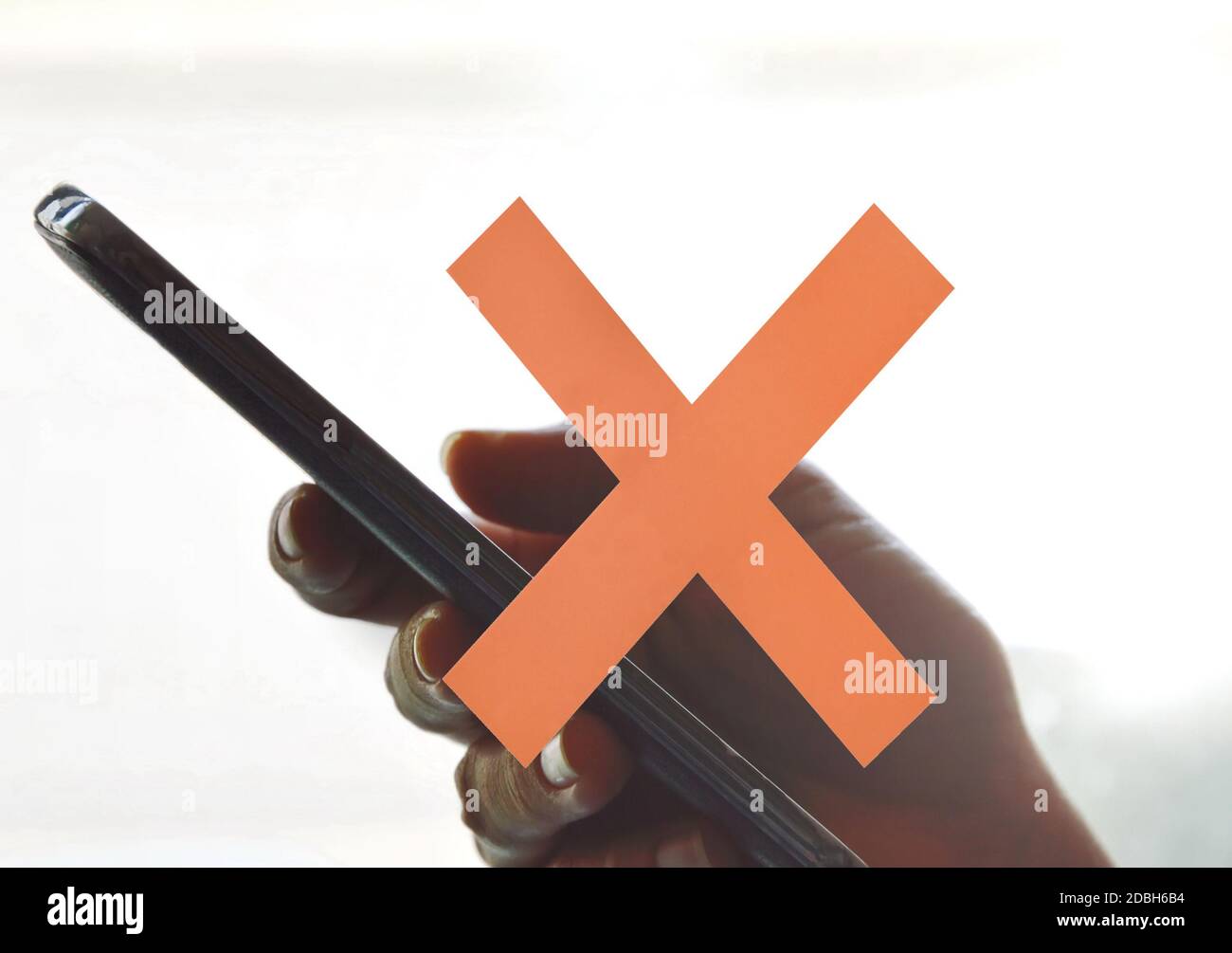 Red cross paper on mobile phone holding in human hand with white ...