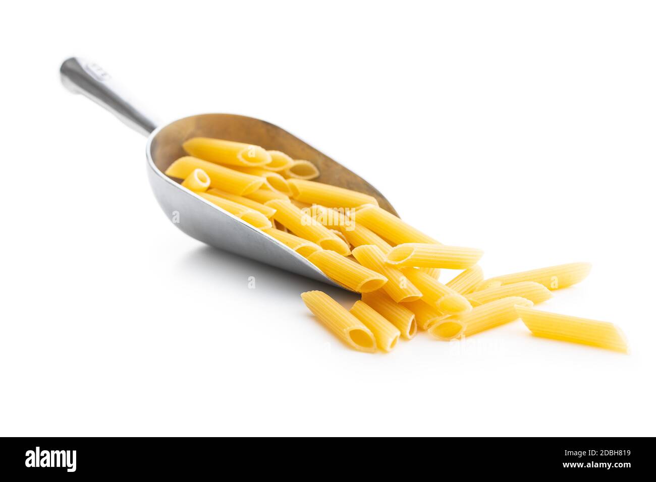 Uncooked penne pasta in scoop. Dried italian pasta isolated on white ...