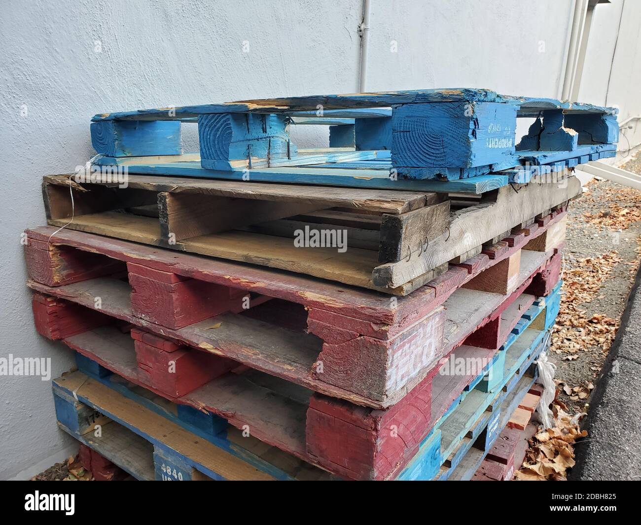 Stack of old, different color wood pallets in a back alley, Walnut ...