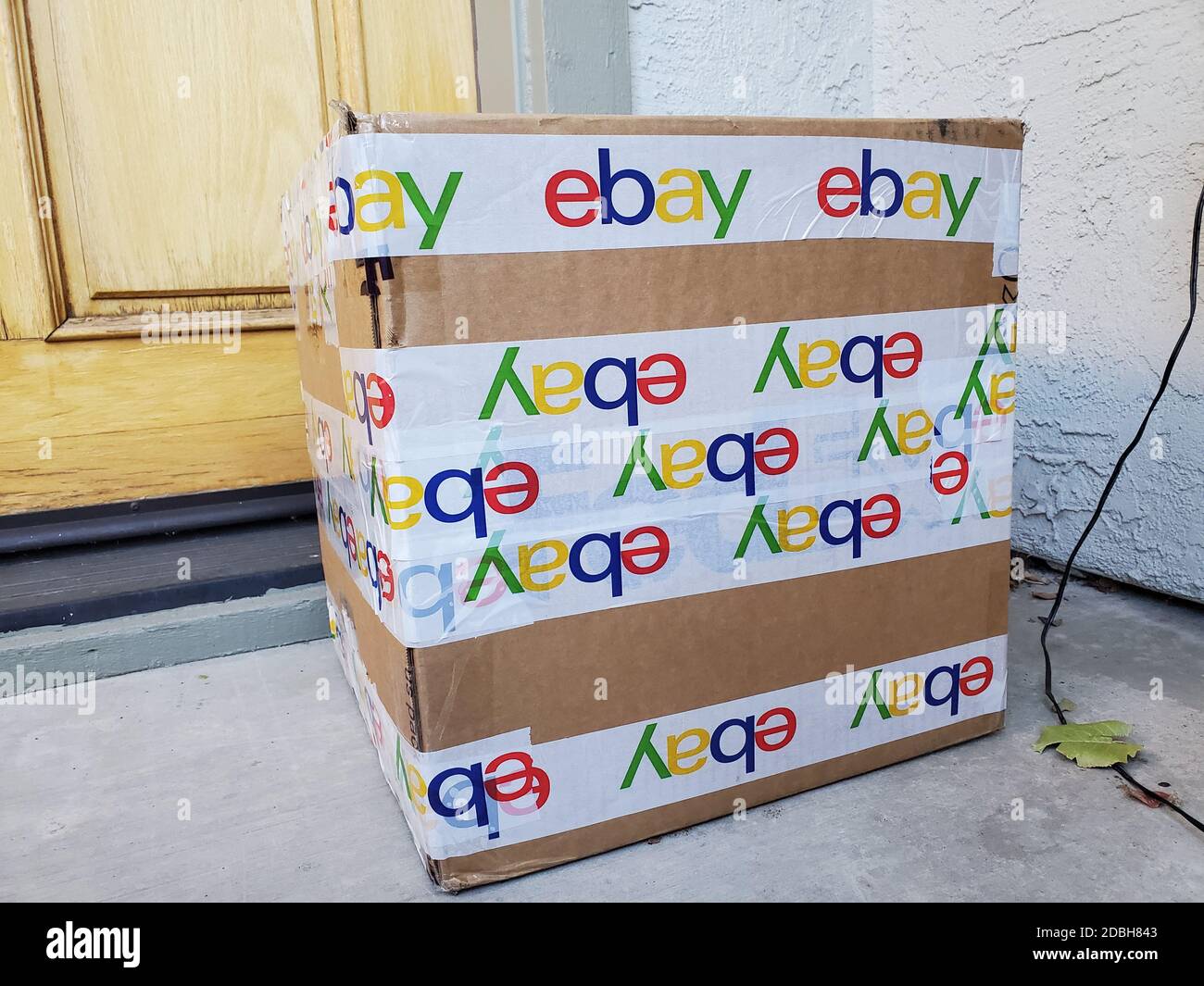 Photograph of a large cardboard shipping box secured with packing tape ...