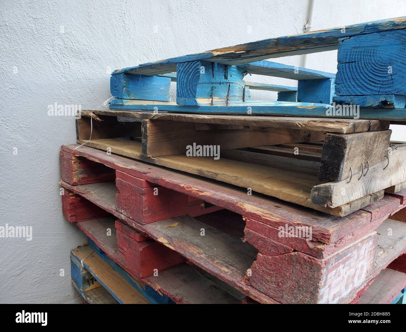 Stack of old, different color wood pallets in a back alley, Walnut ...