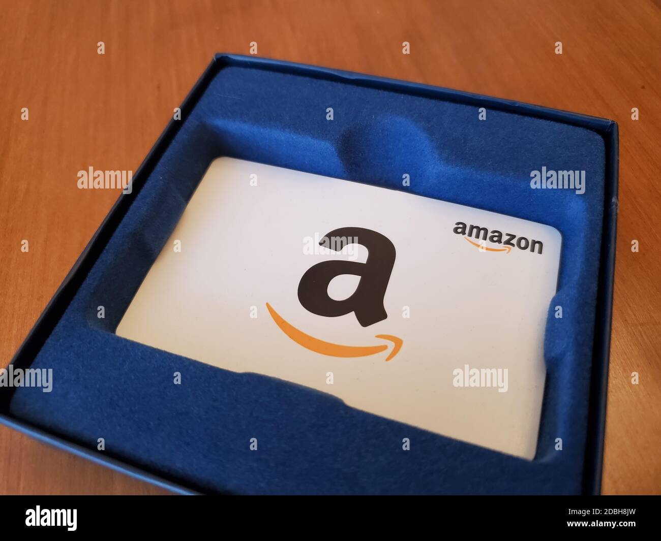 Close-up of a white Amazon gift card in a blue box, featuring the ...