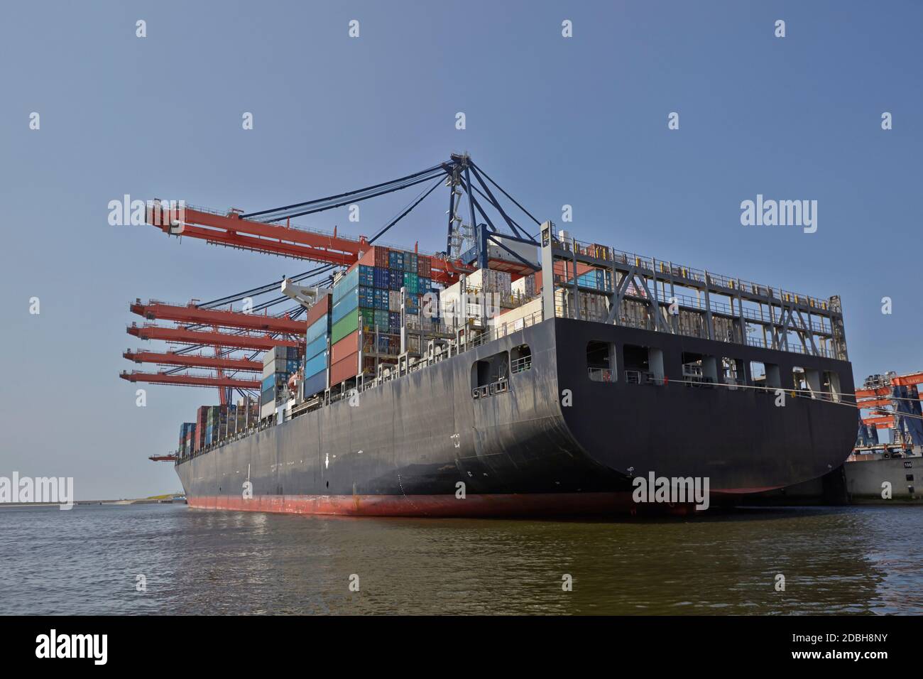 Large harbor cranes loading container ships in the port of Rotterdam ...
