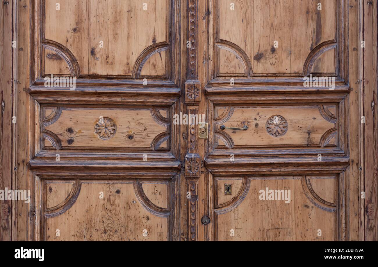 Old Wooden door locked by modern lock Stock Photo - Alamy