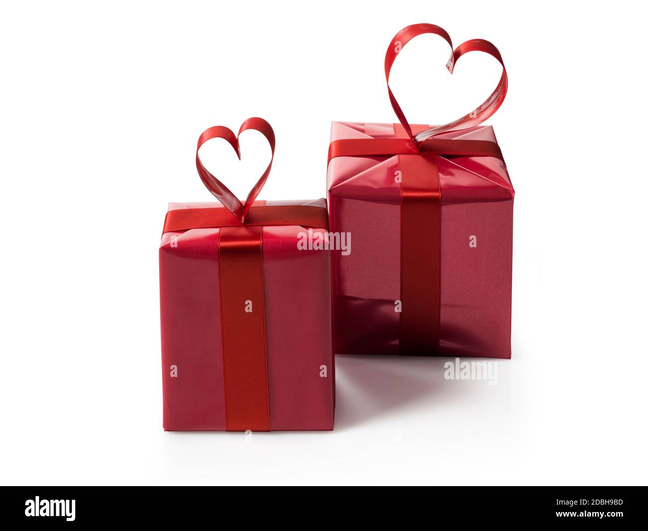 two red gift boxes with red hart shaped ribbon bow, isolated on white ...