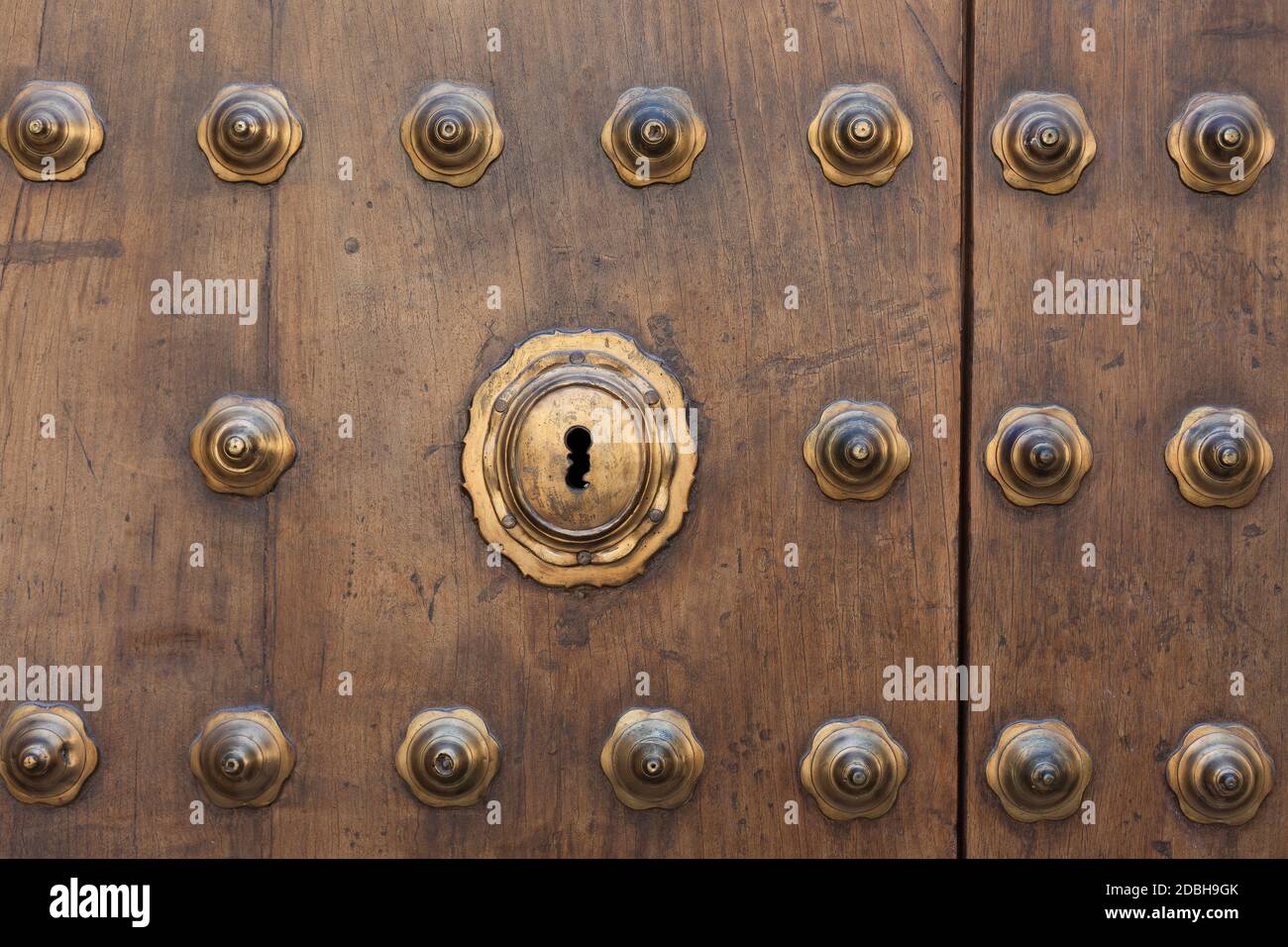 Wooden door with metal spikes Stock Photo - Alamy
