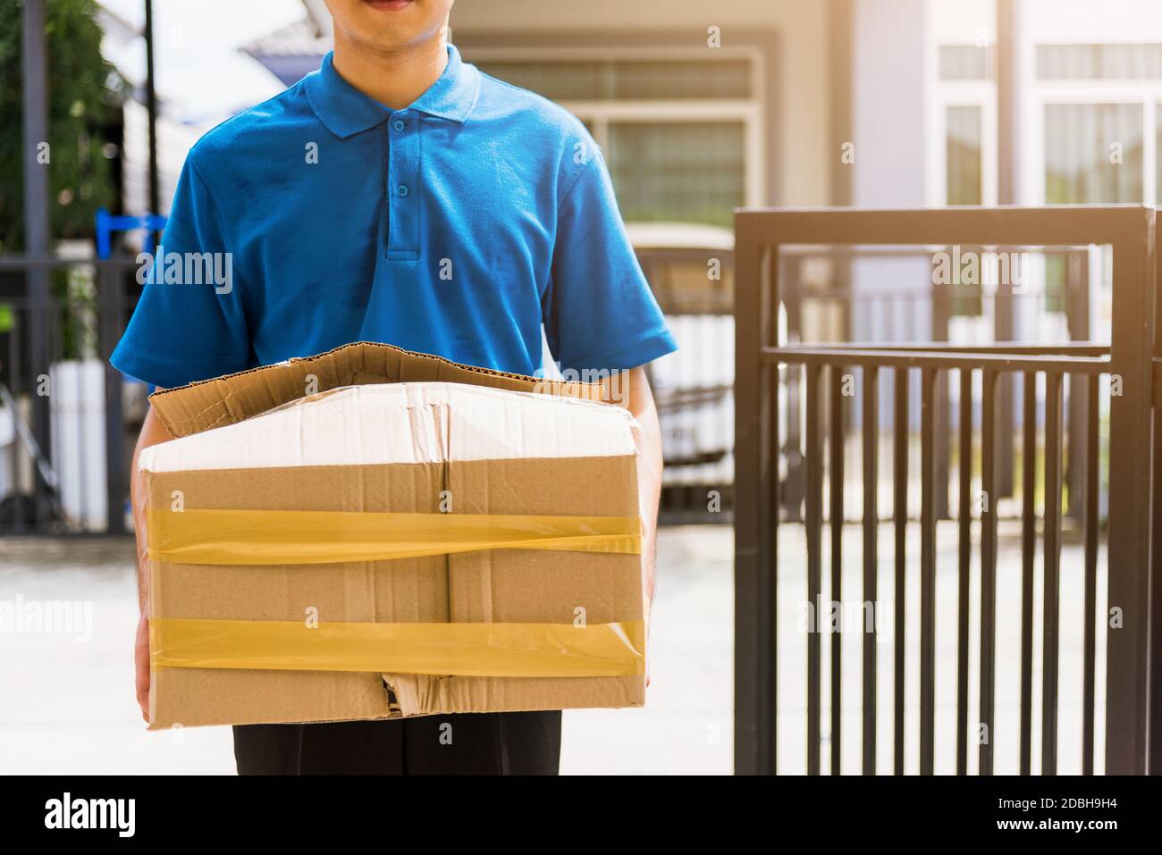 Asian young delivery man in blue uniform he emotional falling courier ...