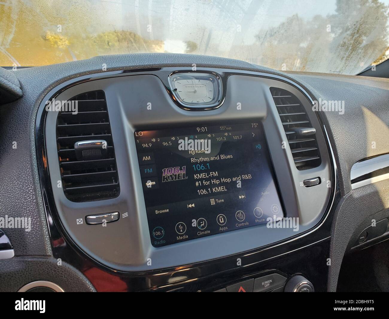Close-up of a digital head unit with a clock and two air-conditioning ...
