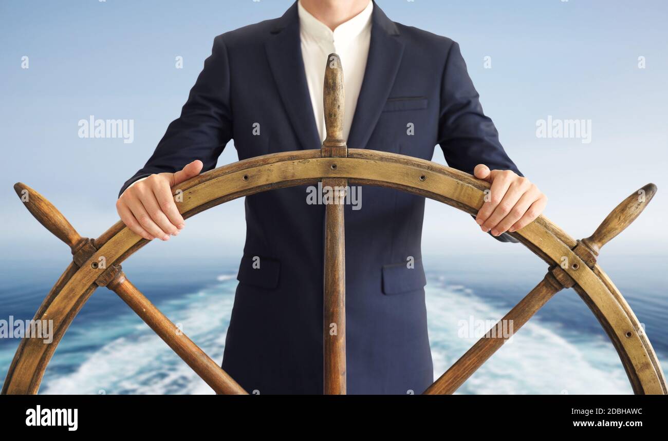 Businessman steering ship hi-res stock photography and images - Alamy