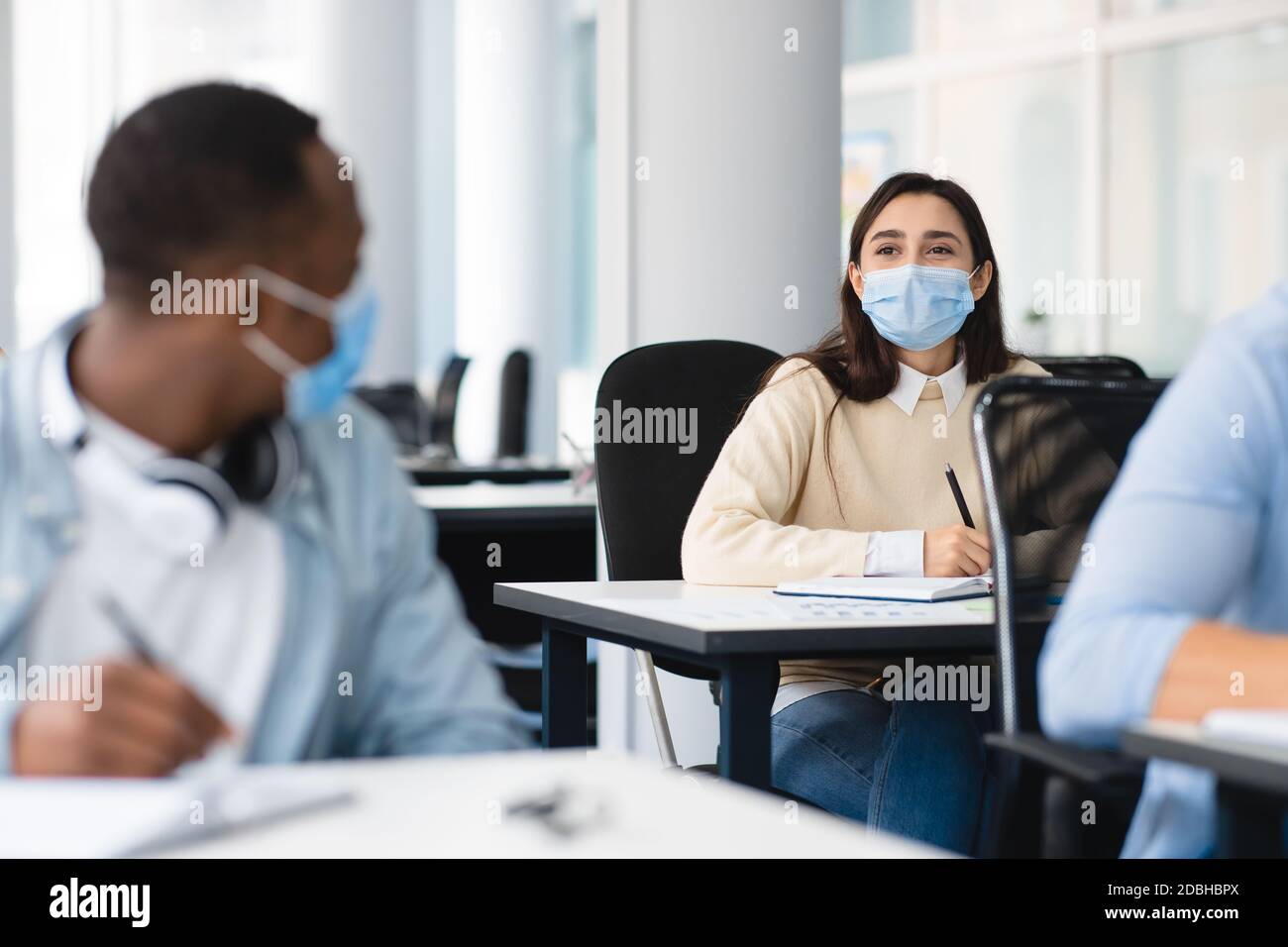 Diverse students wearing medical masks and talking Stock Photo - Alamy