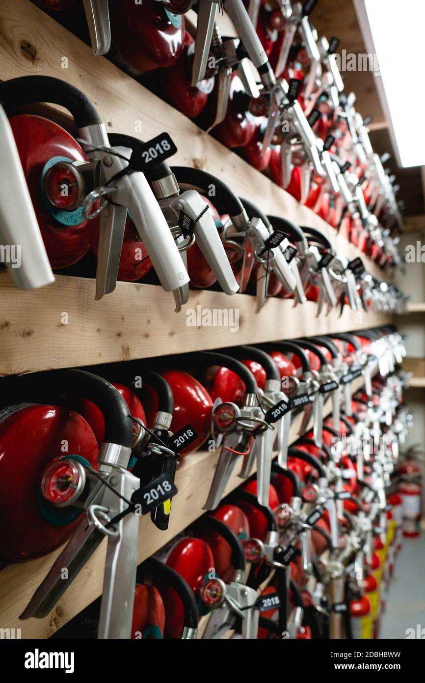Fully equipped Fire extinguishers arranged and held in wood storage ...