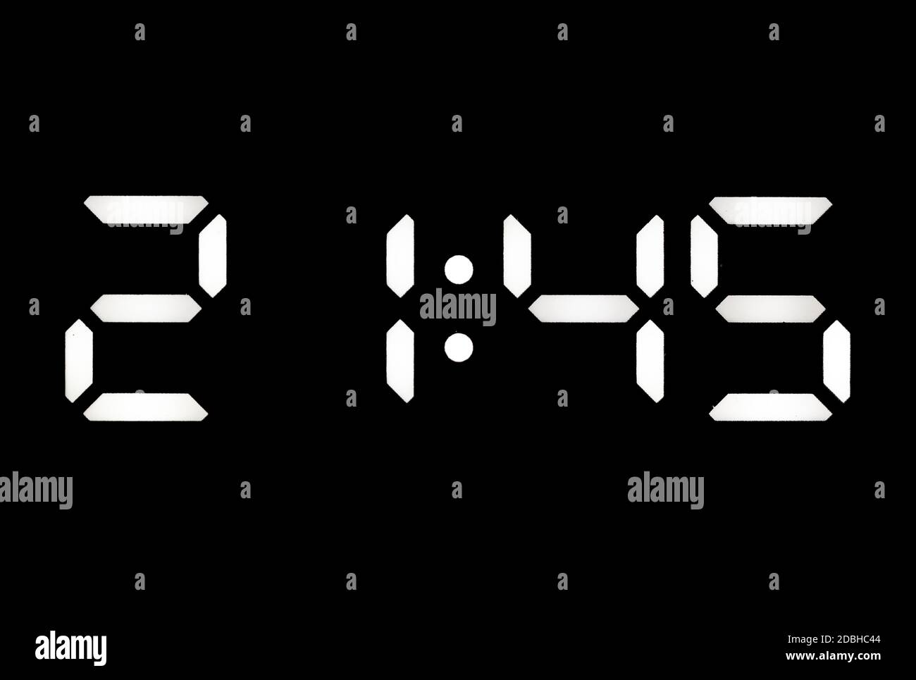 Real white led digital clock on a black background showing time 21:45 ...