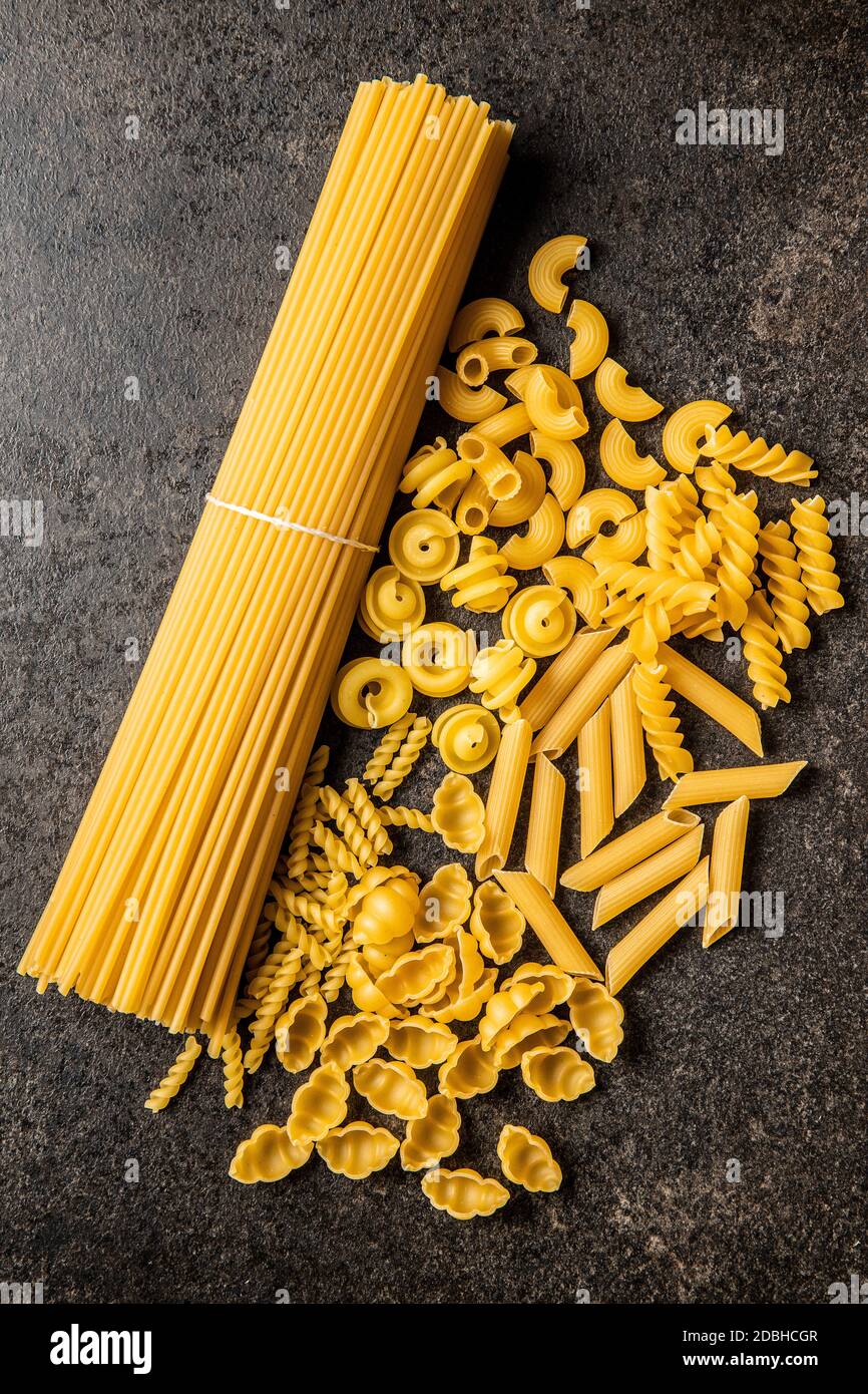 Various types of raw italian pasta on kitchen table. Top view Stock ...