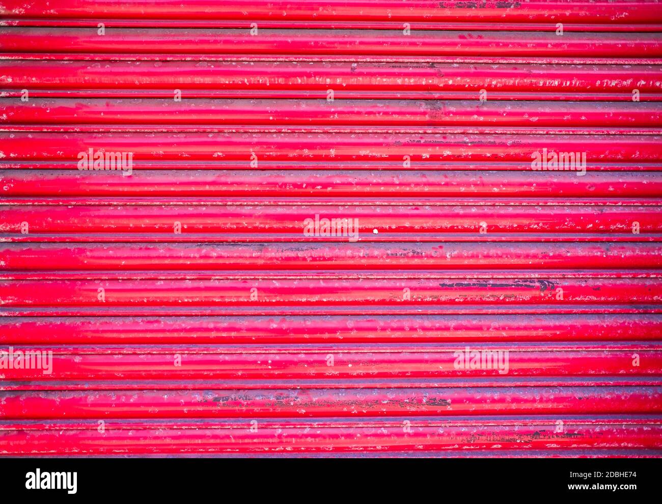 red roller shutter on the door of closed retail premises Stock Photo ...
