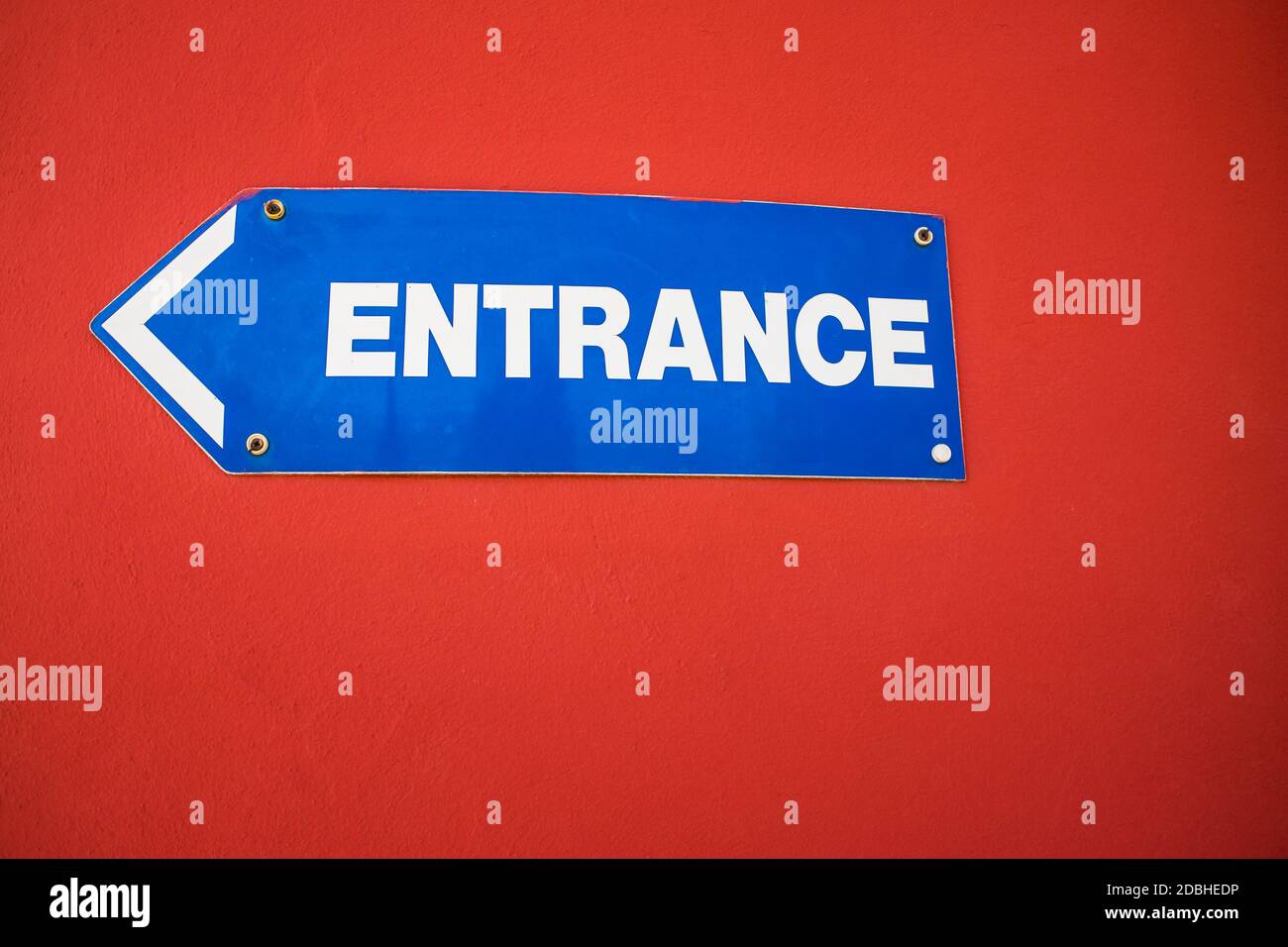 Entrance Sign mounted on a bright red wall UK Stock Photo - Alamy