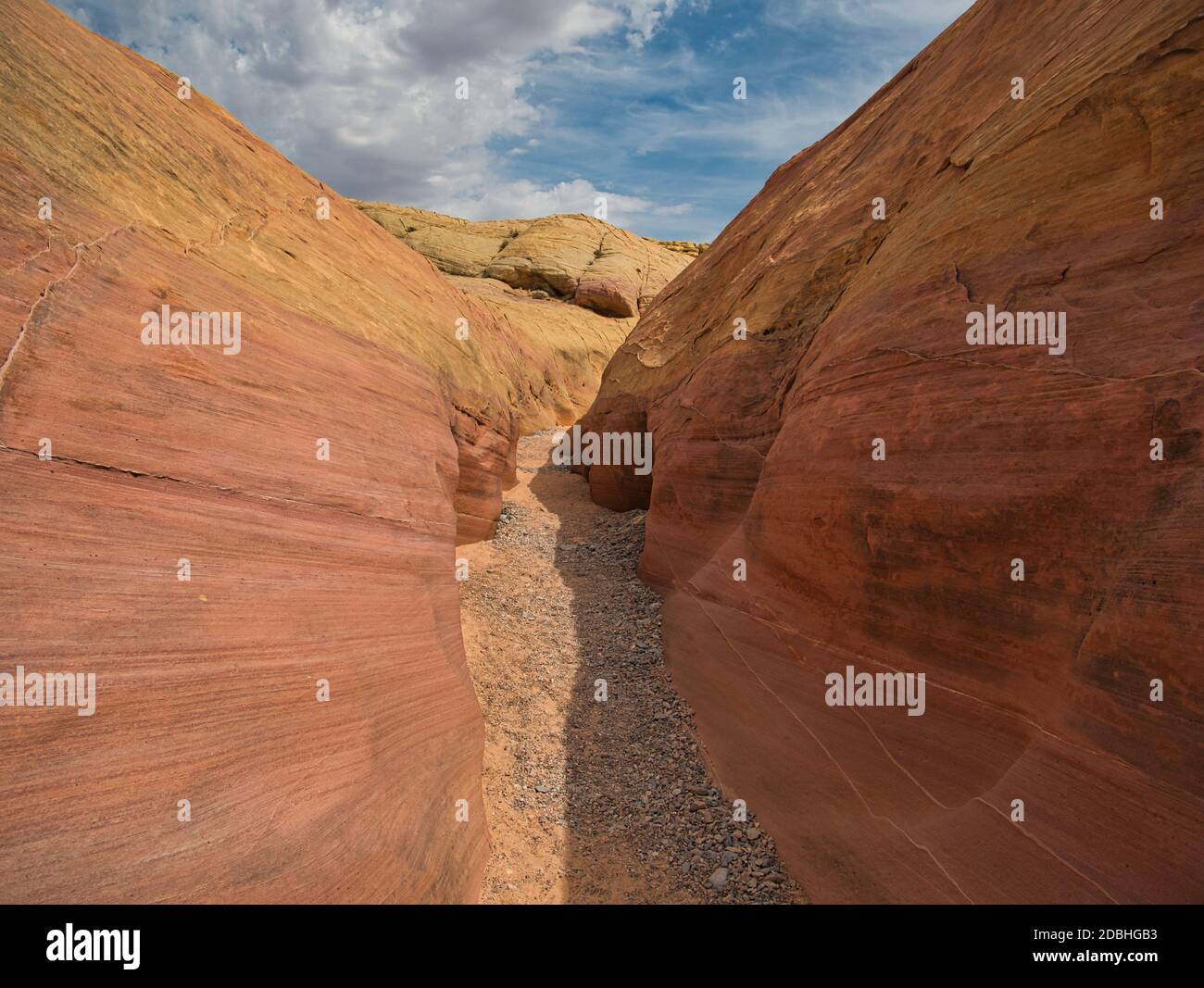 A narrow passage through a small gorge with colourful rocks Stock Photo ...