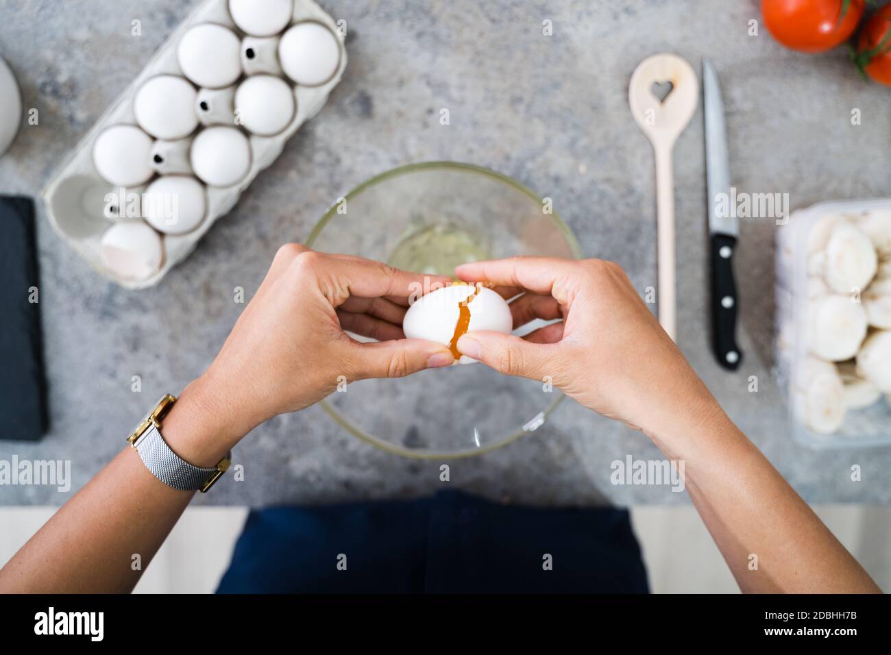 Woman Cooking At Home In Kitchen Breaking Egg Stock Photo - Alamy