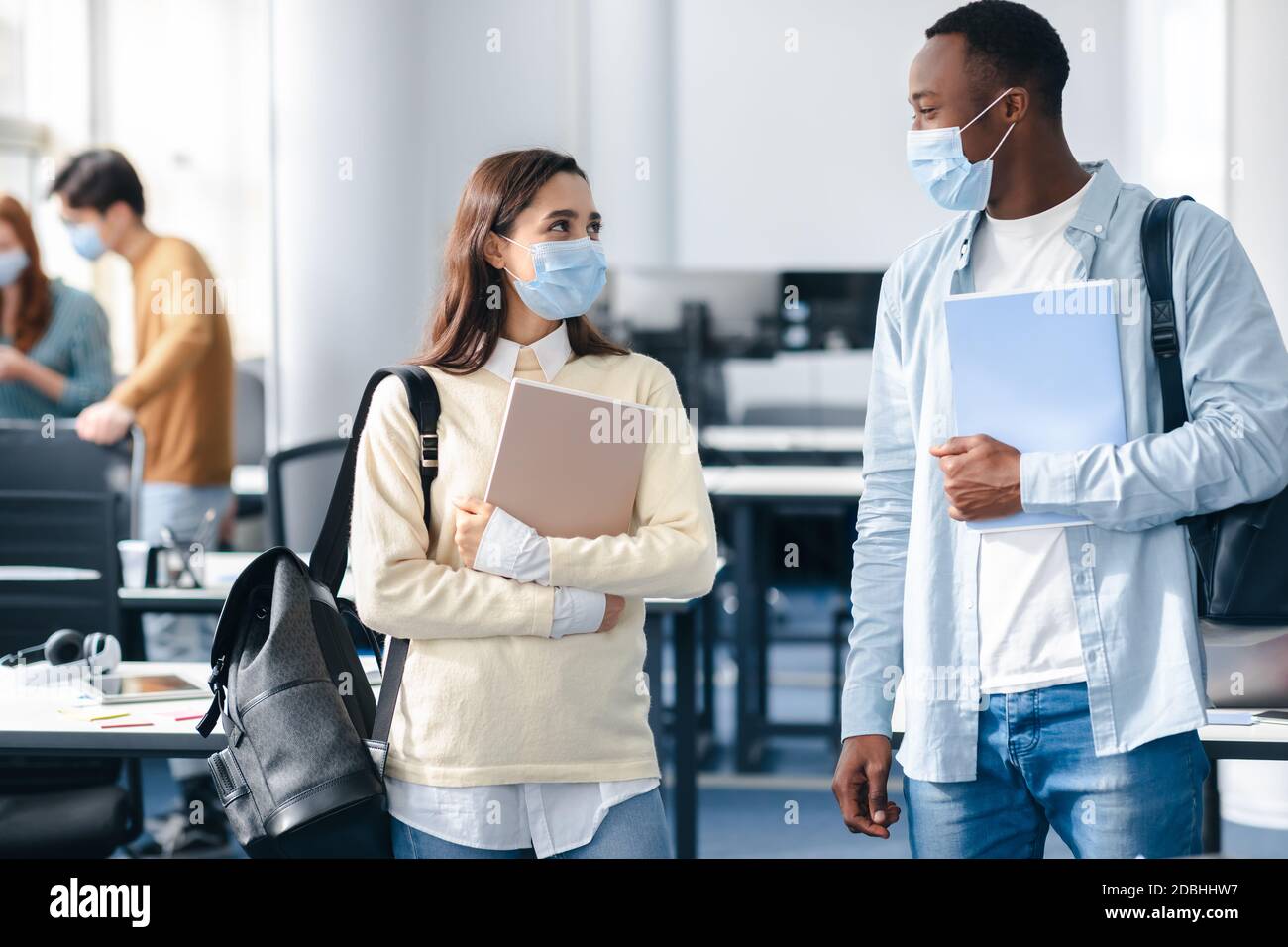 International students wearing medical masks and talking Stock Photo ...