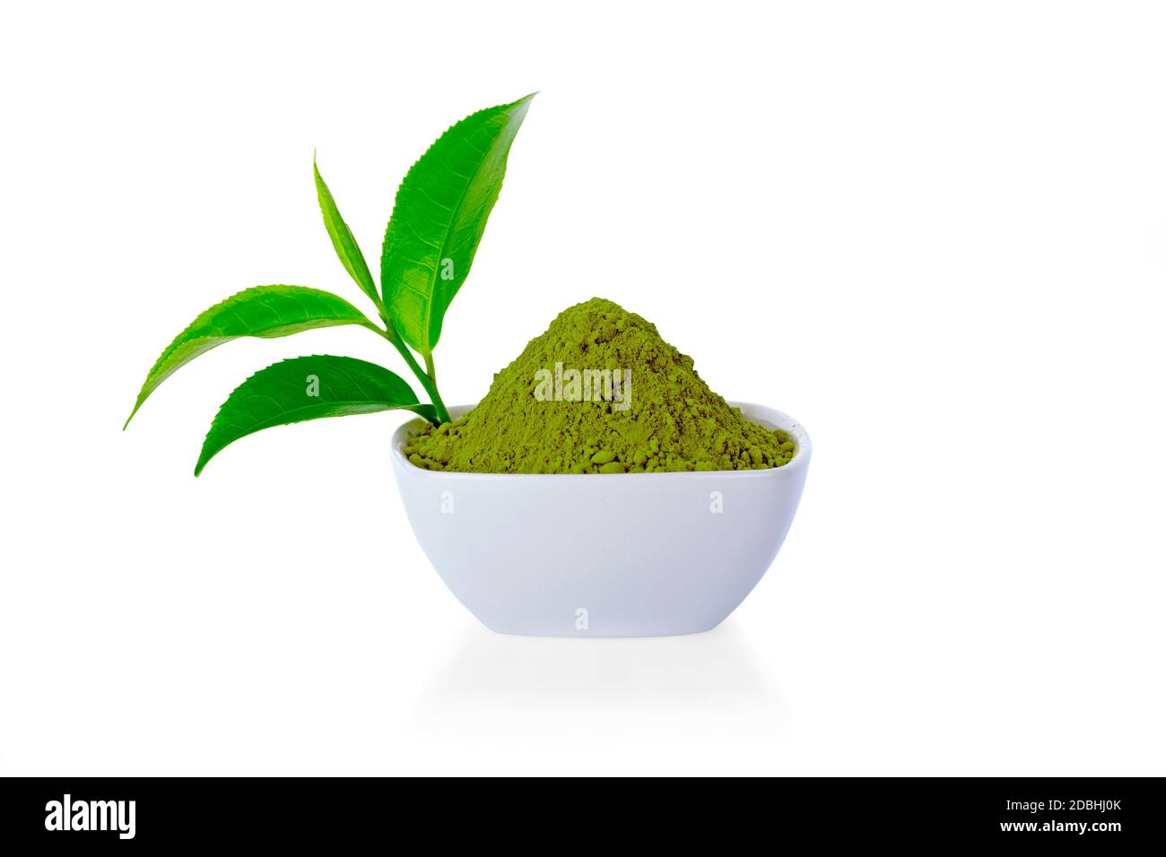 Powder green tea in small bowl and green tea leaf on white background ...