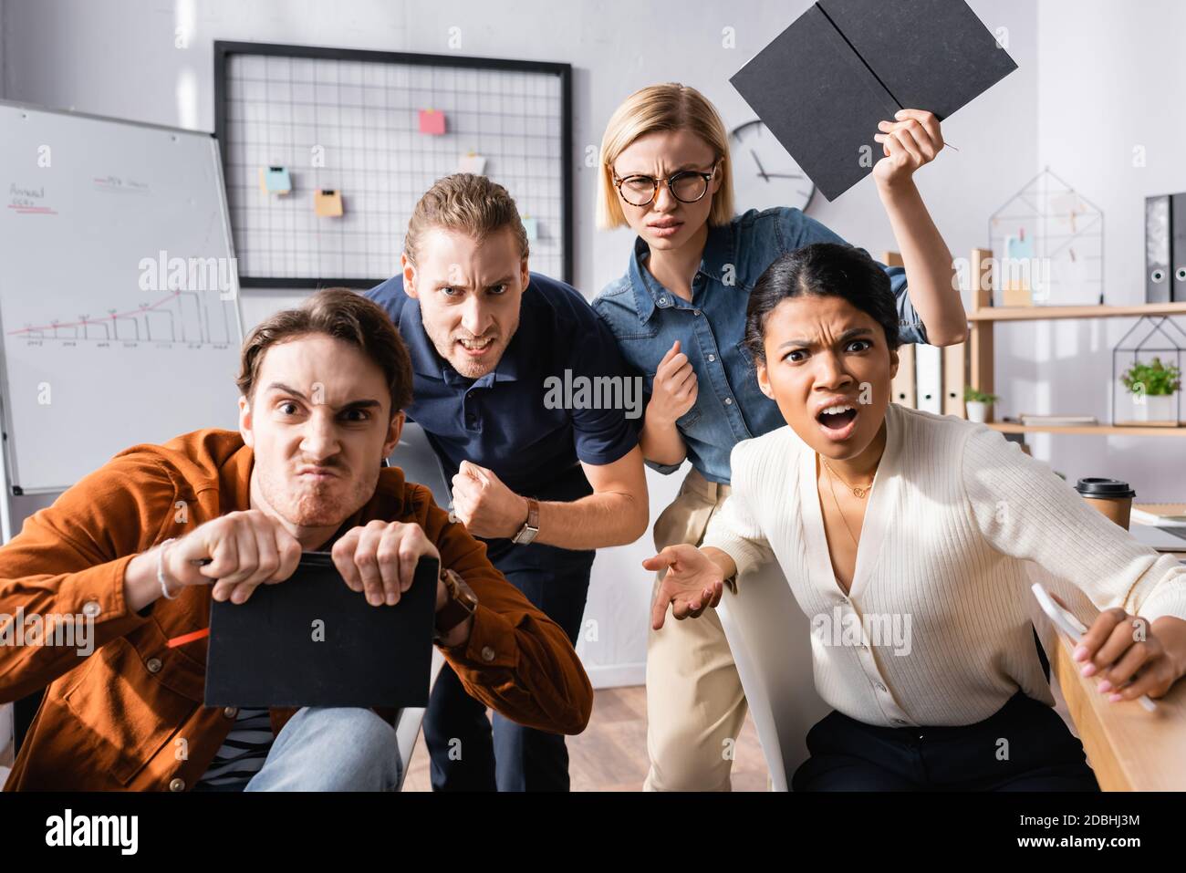 aggressive multicultural businesspeople shouting while looking at ...