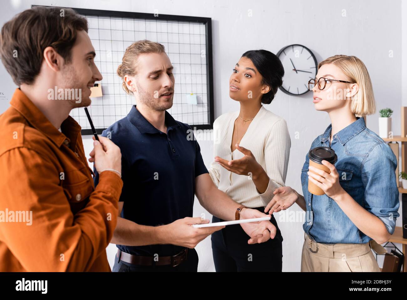 african american businesswoman pointing with hand while talking with ...