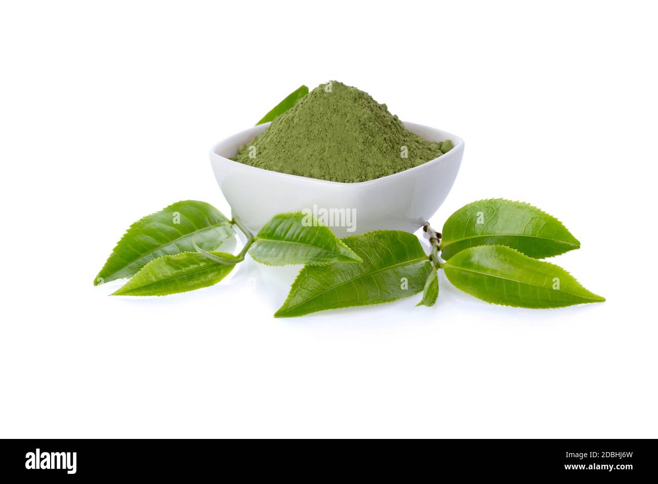 Powder green tea and green tea leaf on white background Stock Photo - Alamy