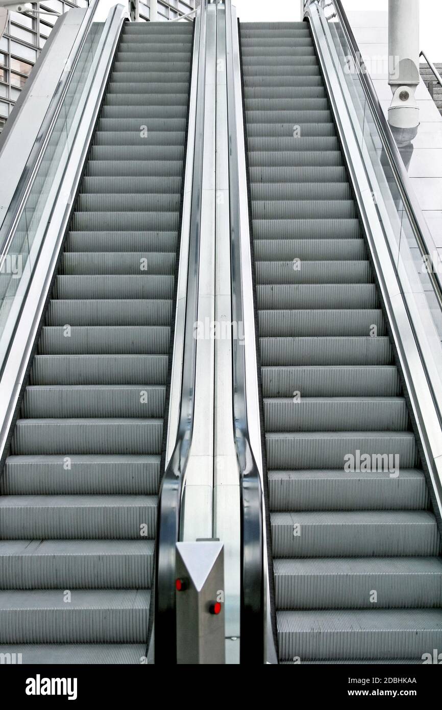 Two parallel automatic escalators in business building Stock Photo - Alamy