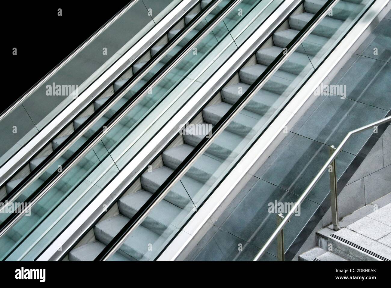 Two parallel automatic escalators from side view Stock Photo - Alamy