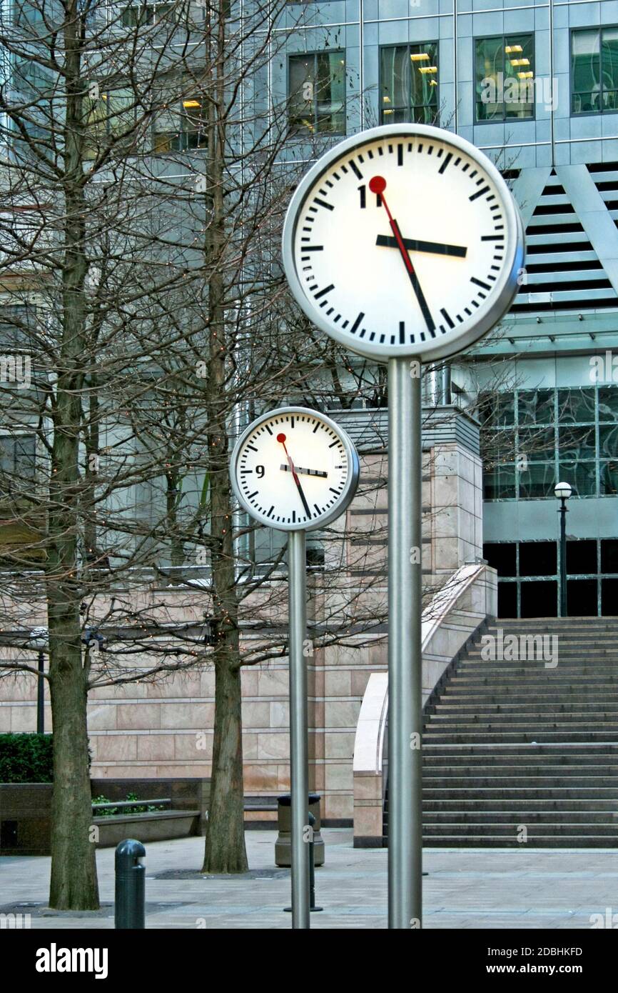 Two public clocks in business part of town Stock Photo - Alamy