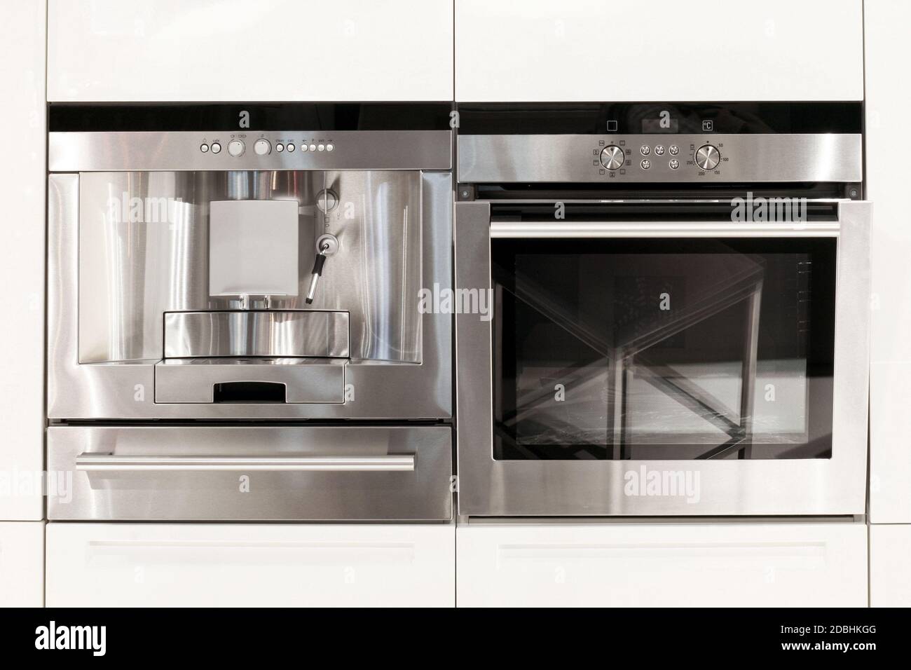 Silver kitchen appliances coffee machine and oven Stock Photo - Alamy