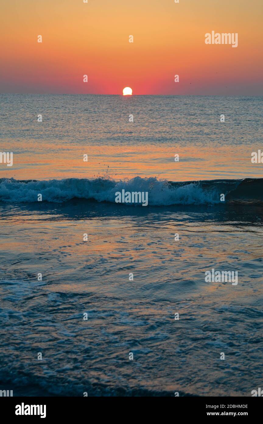 Beautiful summer landscape, sunset at the beach, sparkly sand and waves ...