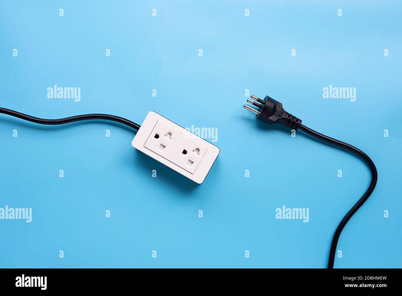 Electrical power strip and plug on blue background. Top view Stock ...