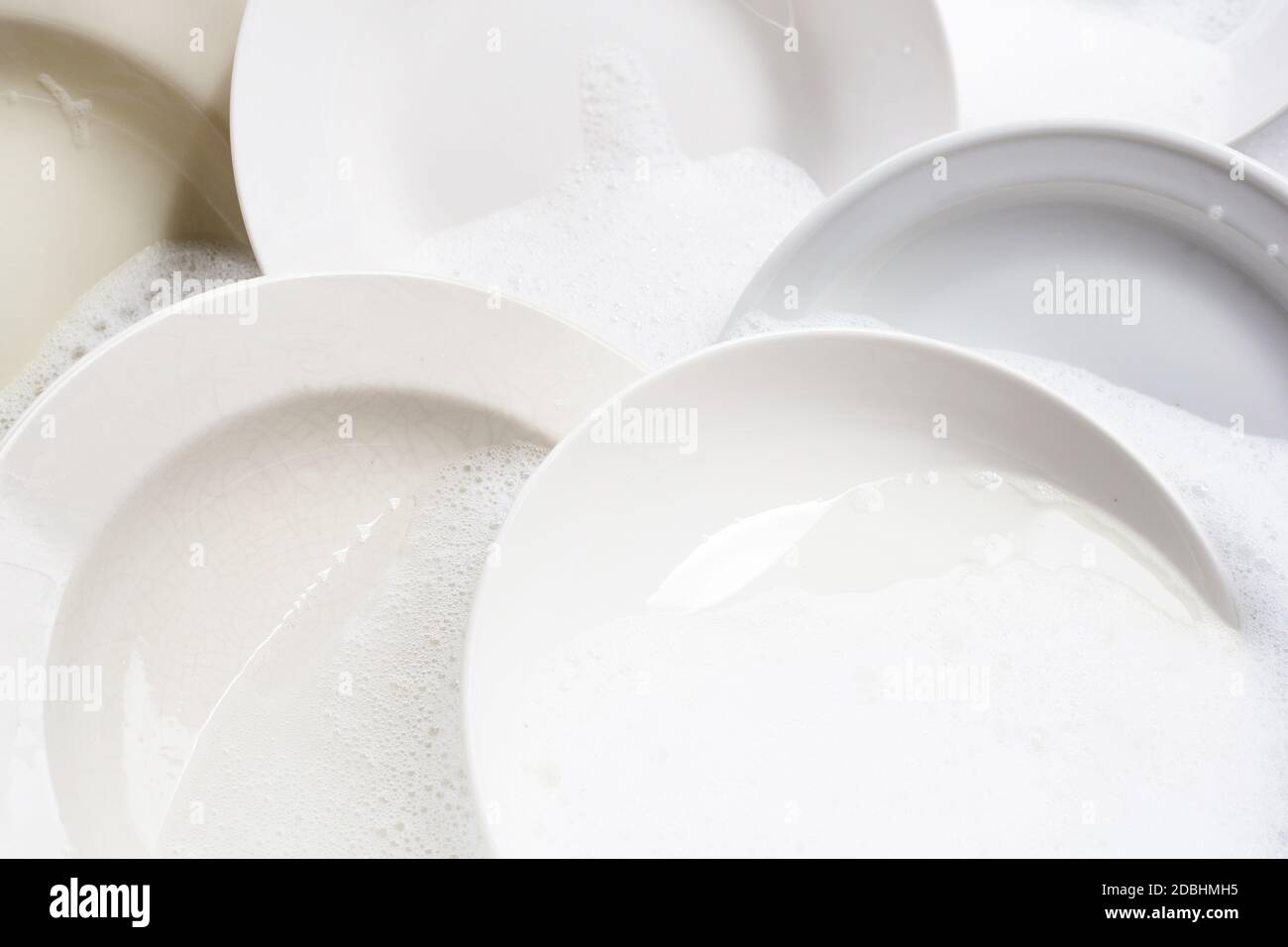 Dish washing, Dirty dishes soaking in kitchen sink Stock Photo - Alamy