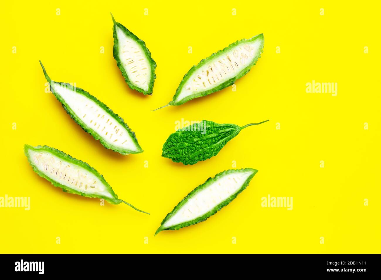 Bitter gourd on yellow background. top view Stock Photo - Alamy