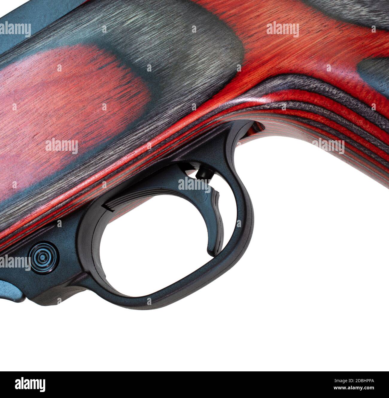 Trigger and safety on a rifle with a red and black laminated wood stock ...