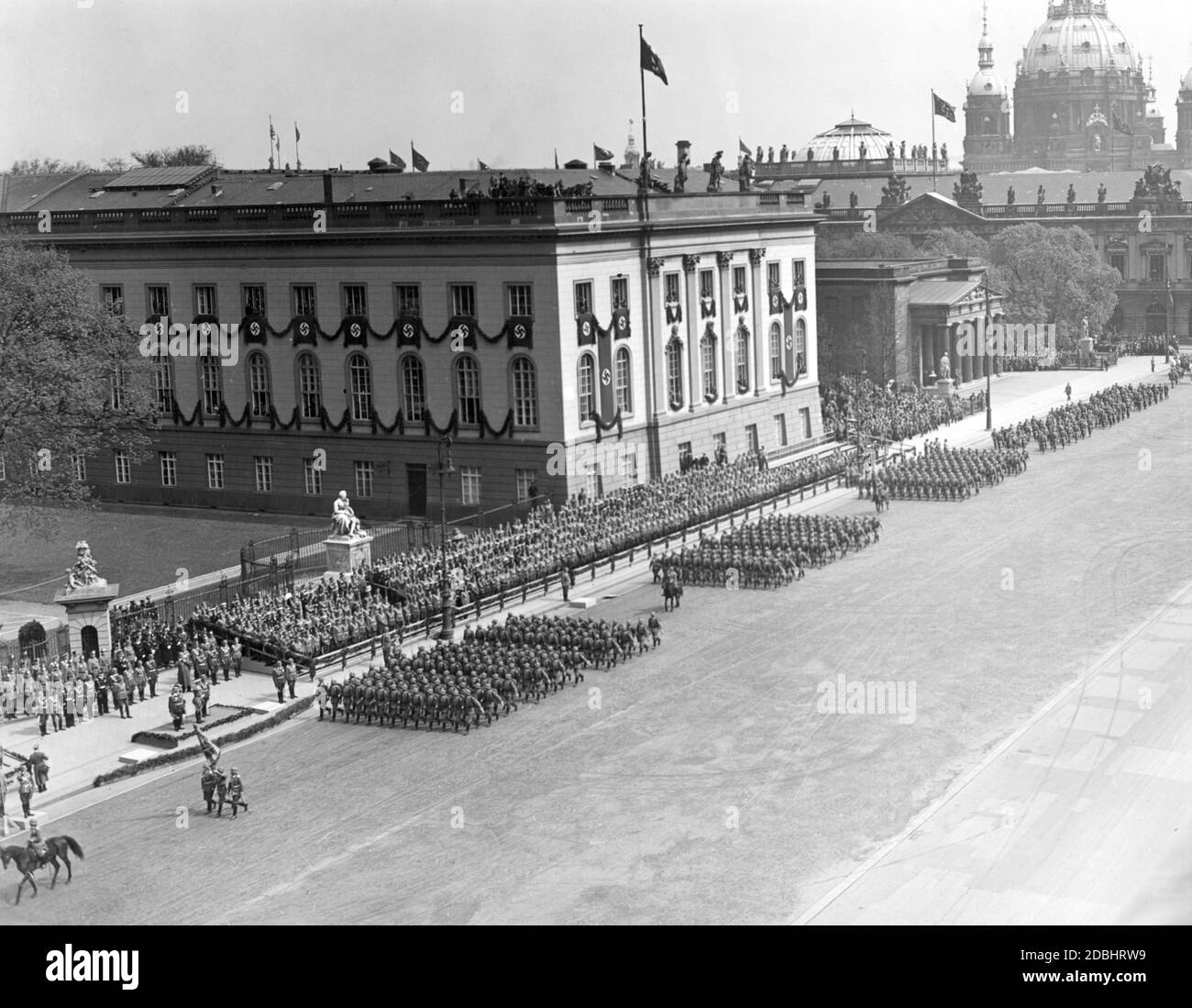"Adolf Hitler stands on a podium in front of the university (left), and ...