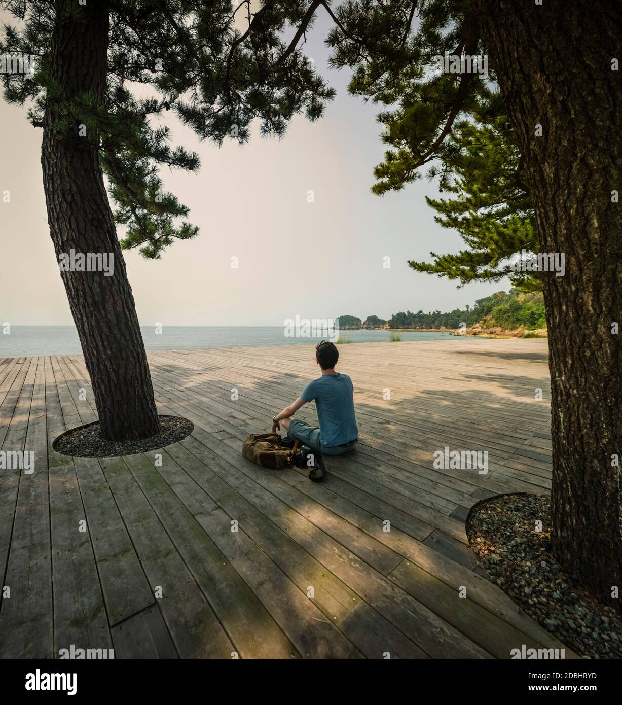 Young male relaxing on a boardwalk, Naoshima, Japan Stock Photo - Alamy