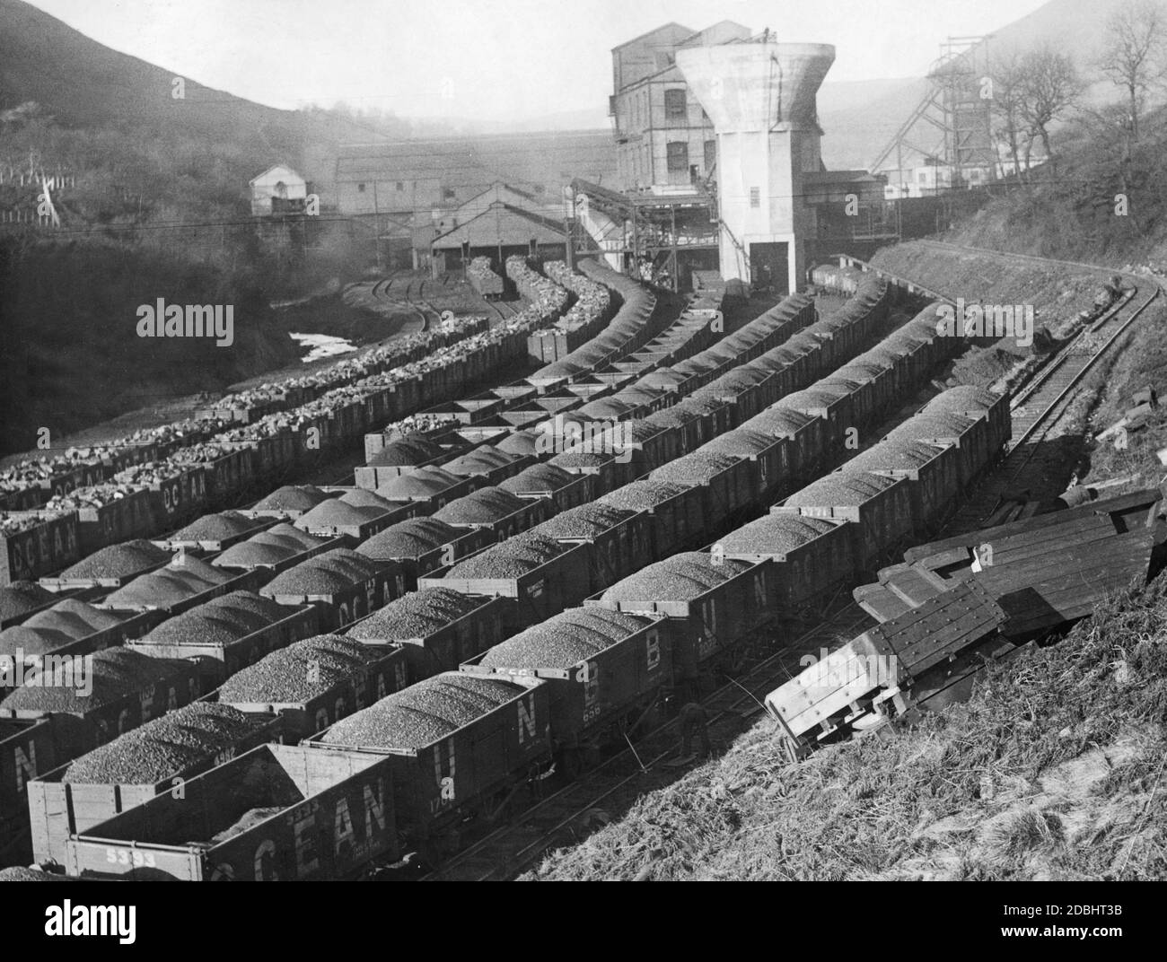 Freight trains with fully loaded wagons wait outside the station during ...