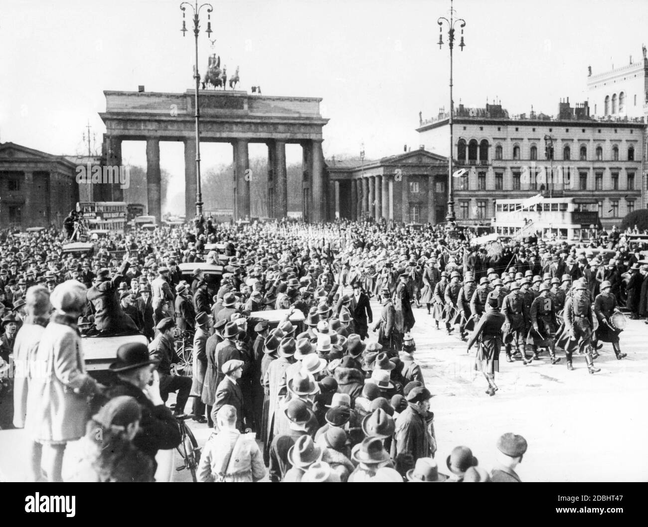 A crowd watches the Reichswehr during a guard parade in front of the ...