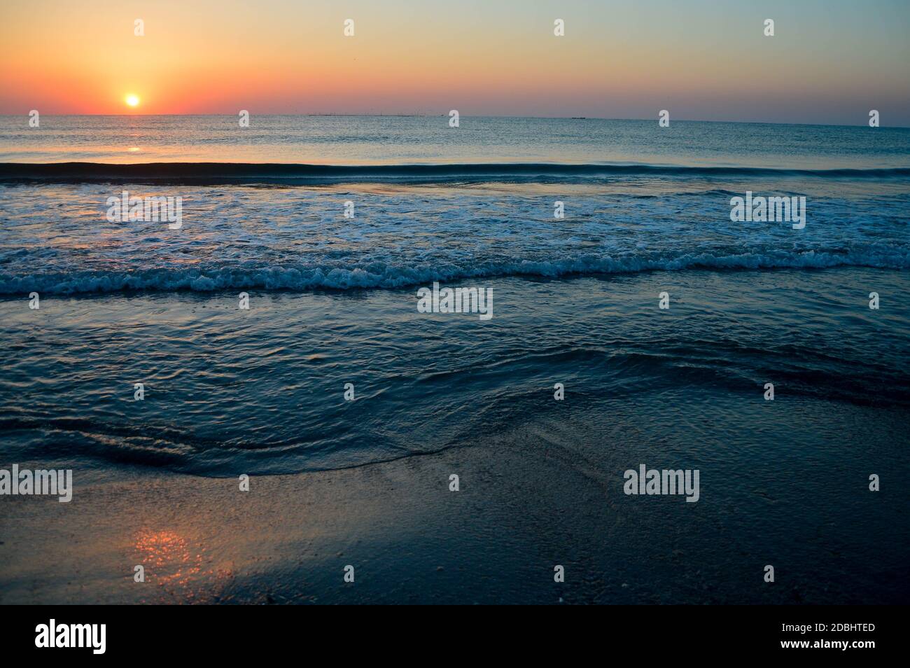 Beautiful summer landscape, sunset at the beach, sparkly sand and waves ...