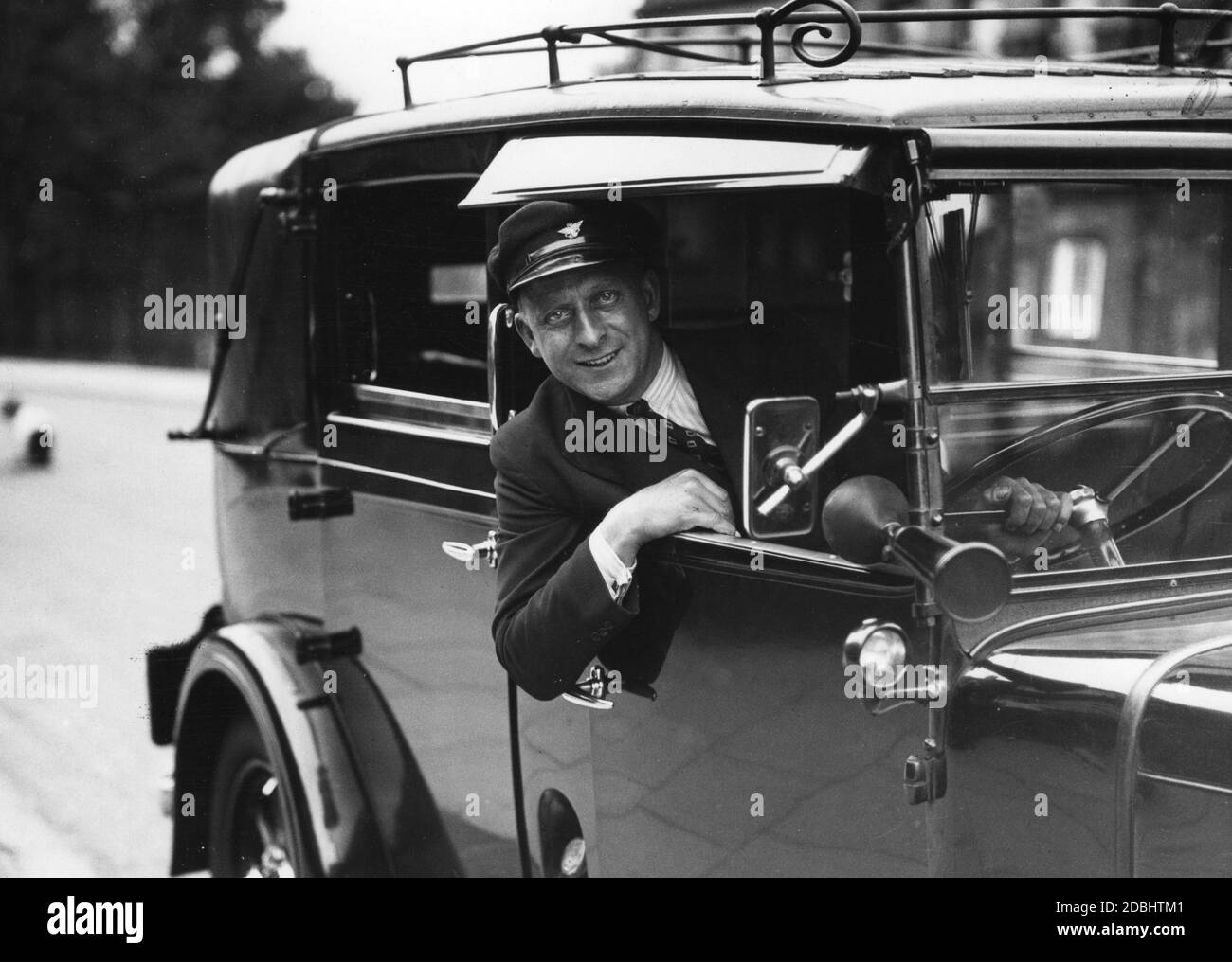 A cab driver in London looks out the side window of his cab Stock Photo ...