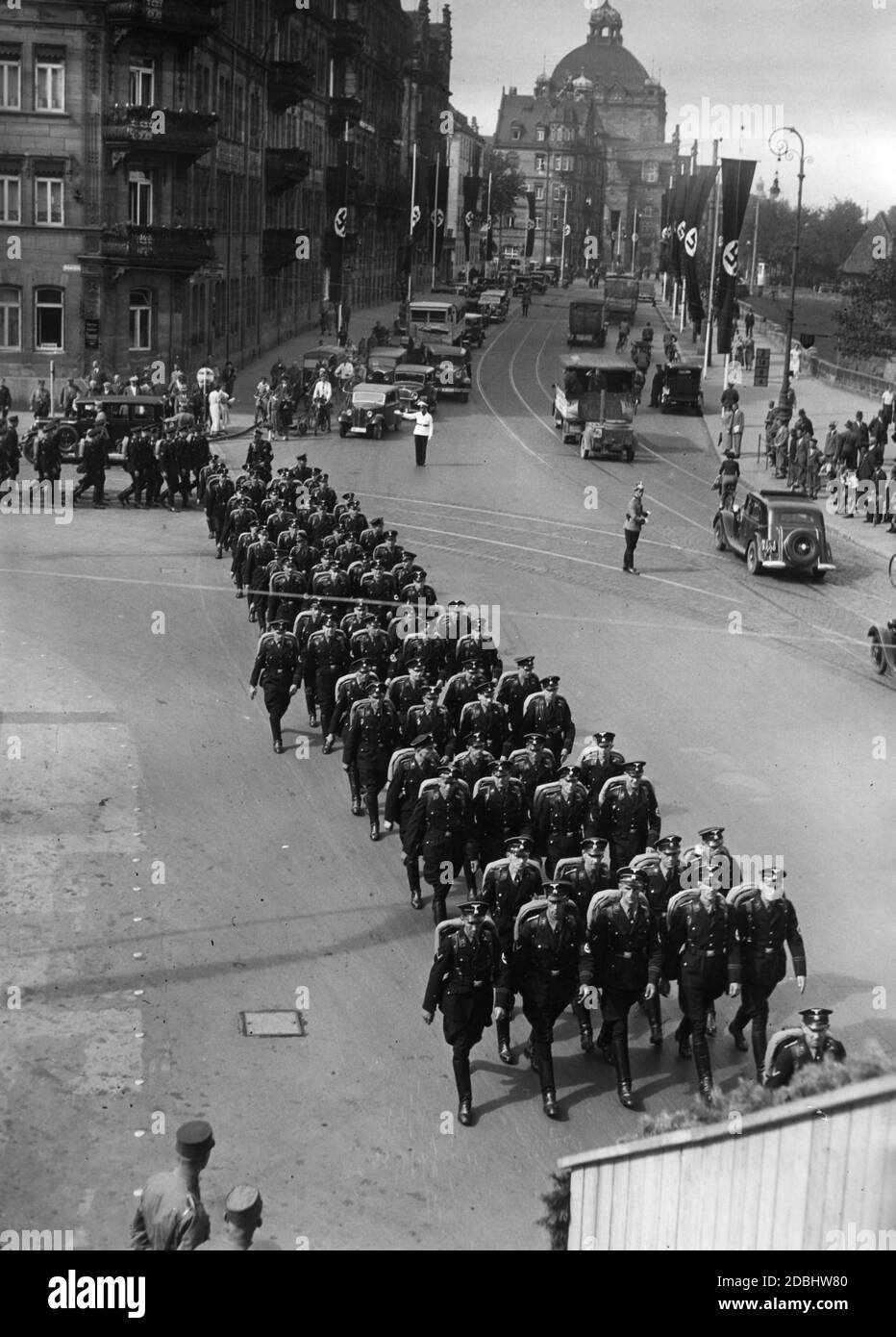 After their arrival, SS troops march through Nuremberg, while police ...