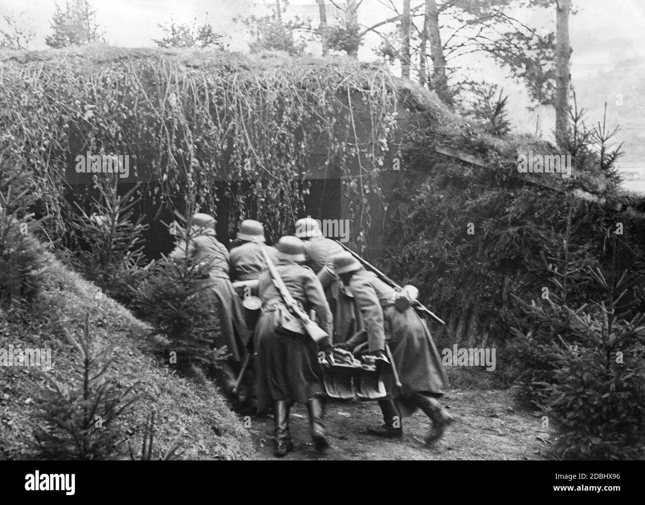 Soldiers drive an artillery gun back into a armoured facility of the ...