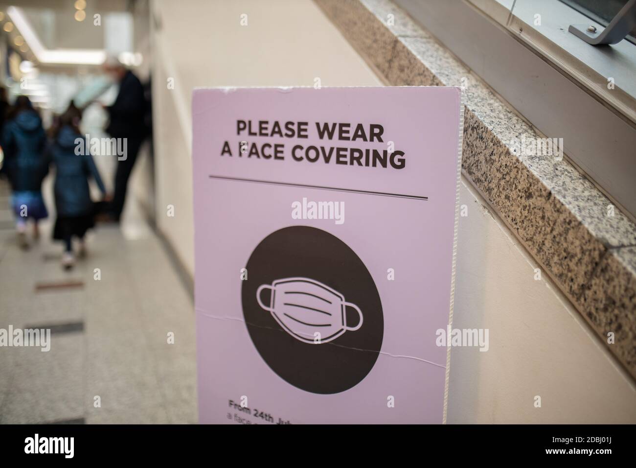 Sign next to escalators requesting people to use a face mask Stock ...