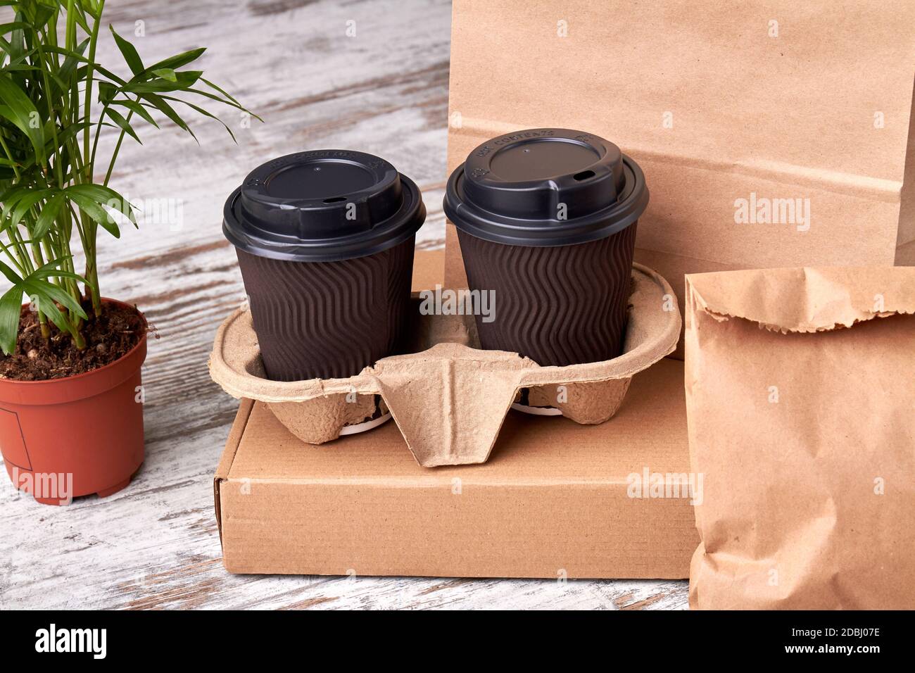 Two closed paper cups of coffee in cupholder Stock Photo - Alamy